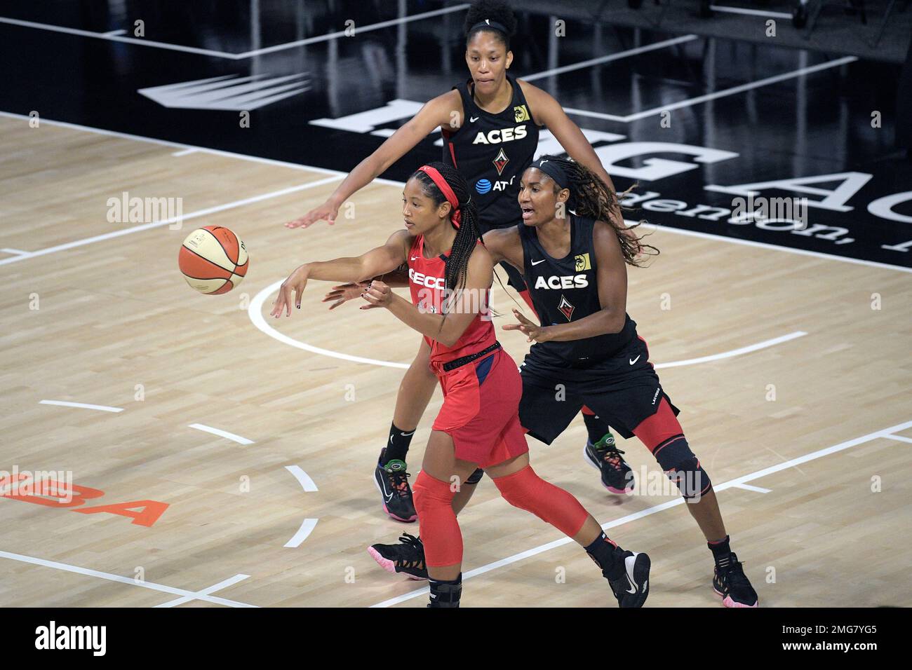 Washington Mystics guard Stella Johnson, left, passes the ball in front ...
