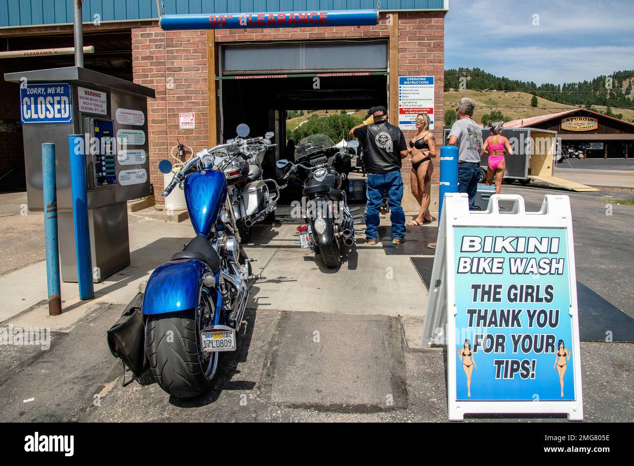Women dressed in bikinis wash motorcycles at Bikini Bike Wash during ...
