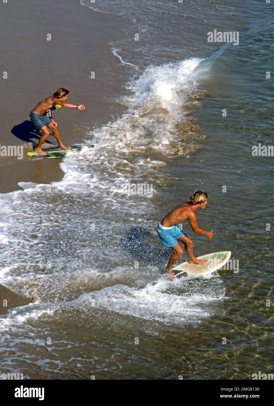Young men Skim boarding on the coast of Southern California, USA Stock ...
