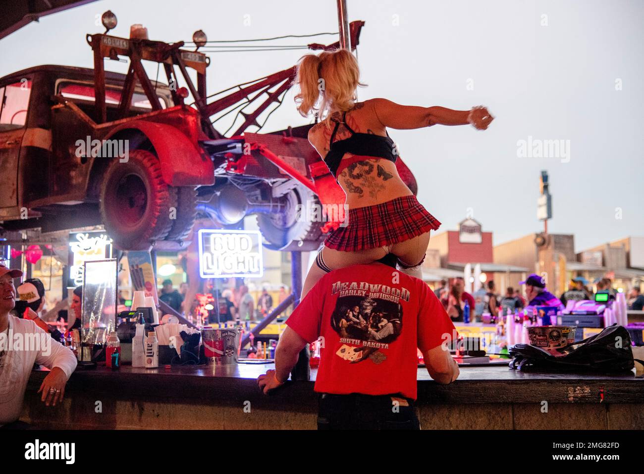 A dancer performs on a bar at the Full Throttle Saloon during the 80th ...