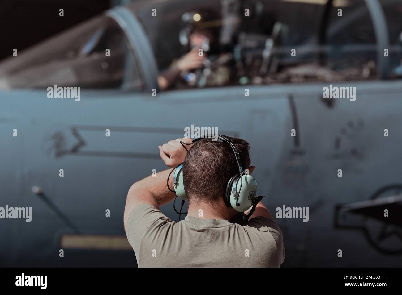 A U.S. Air Force crew chief relays signals to a F-15E Strike Eagle ...