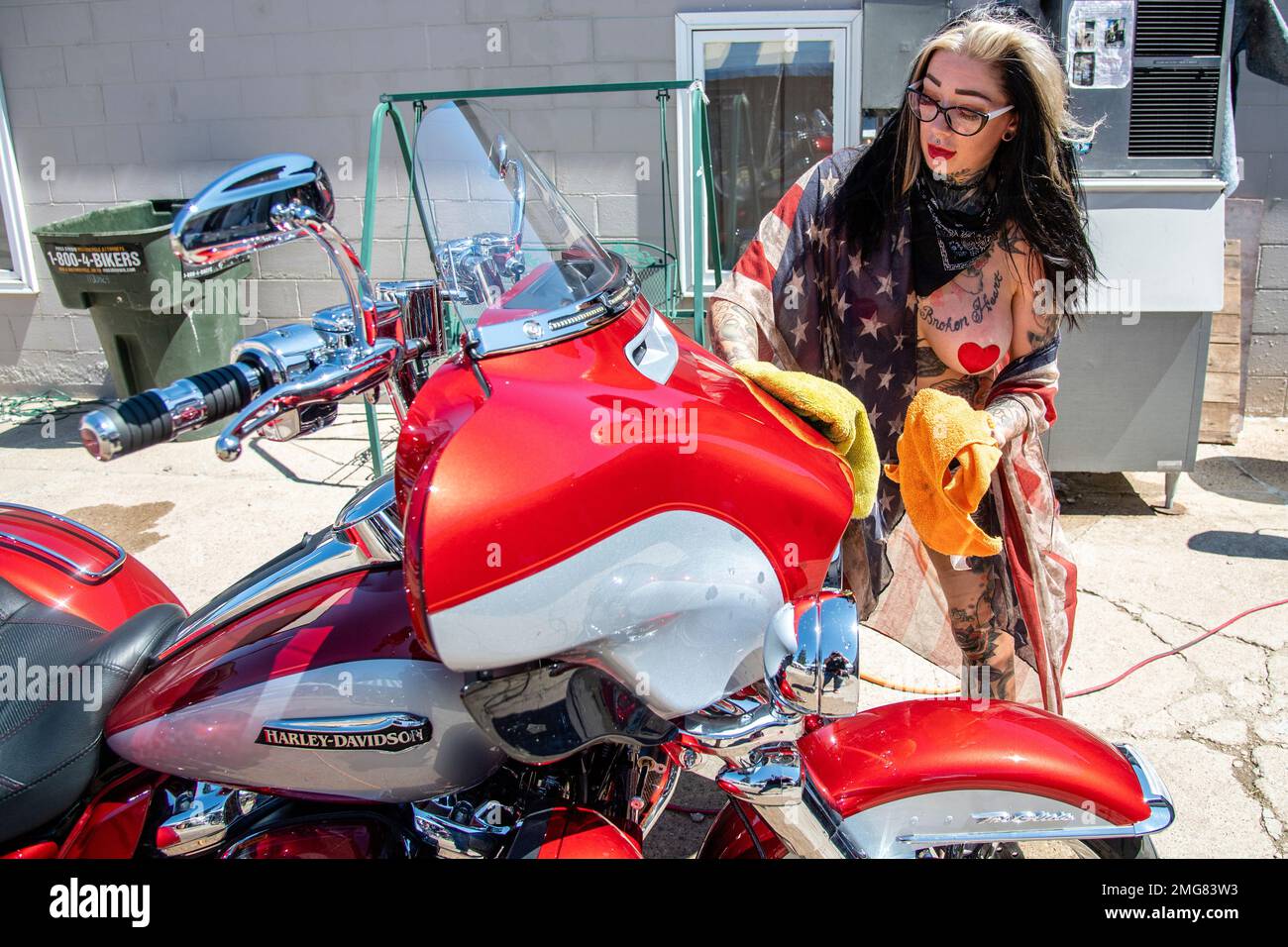 A women dressed in a bikini washes a motorcycle at Fat Tony's Bikini ...