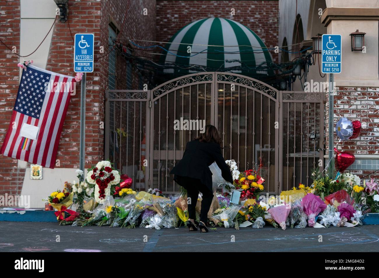 Vice President Kamala Harris lays flowers at a memorial set up outside ...