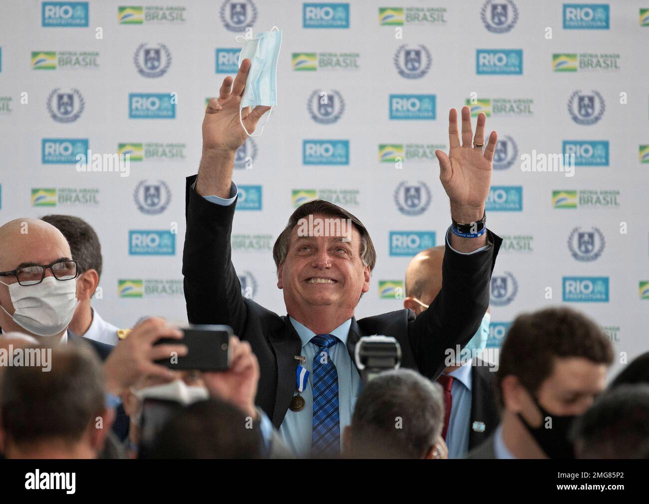 Brazil's President Jair Bolsonaro holds up his mask, amid the COVID-19 ...