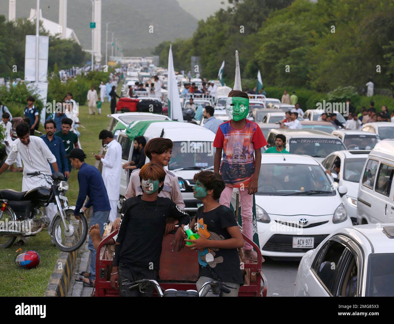 People march on a road to celebrate Independence Day, in Islamabad ...