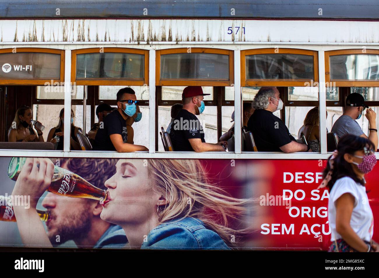 Passengers wear face masks for protection against the new coronavirus ...