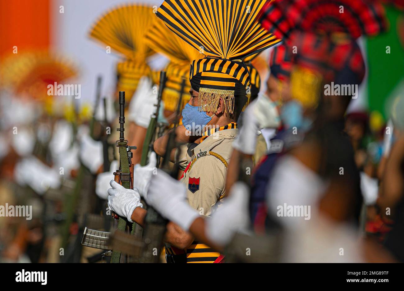 Indian paramilitary soldiers wearing face masks participate in the ...