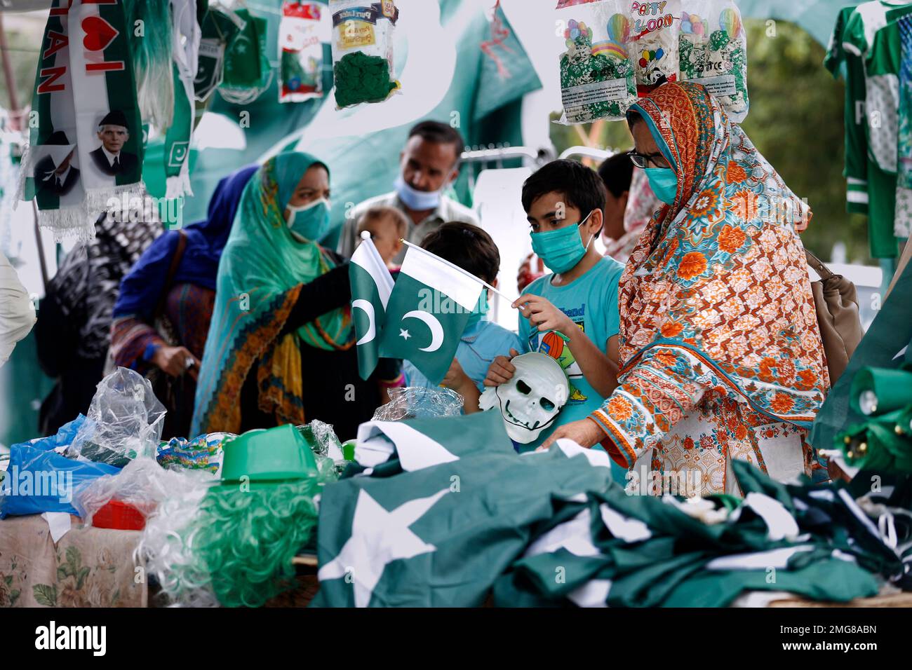People shop Pakistani national flags, badges and masks and other stuff ...