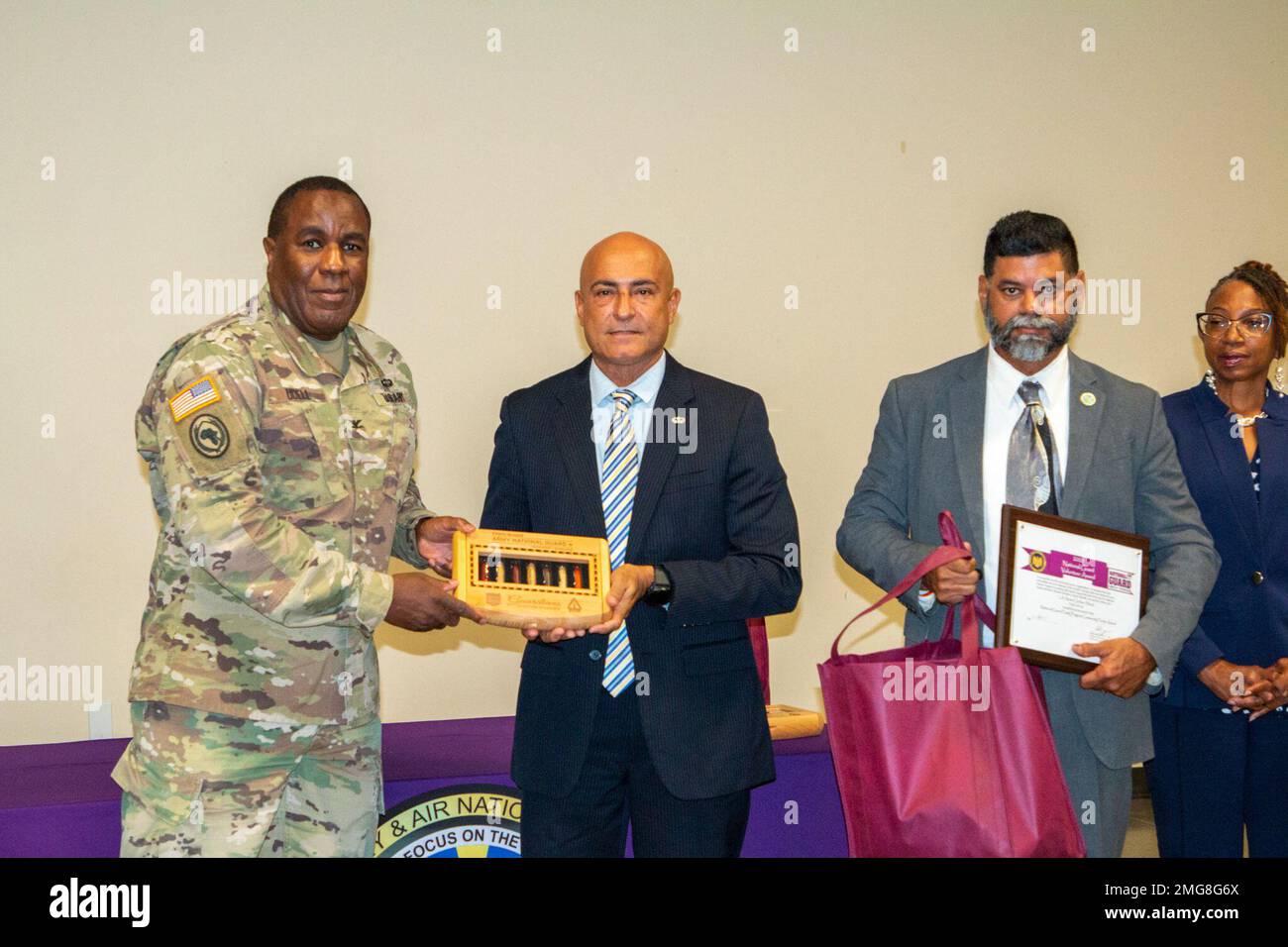Col. Ivan Udell, left of center, shakes Mr. Angel Diaz hand, who is the ...