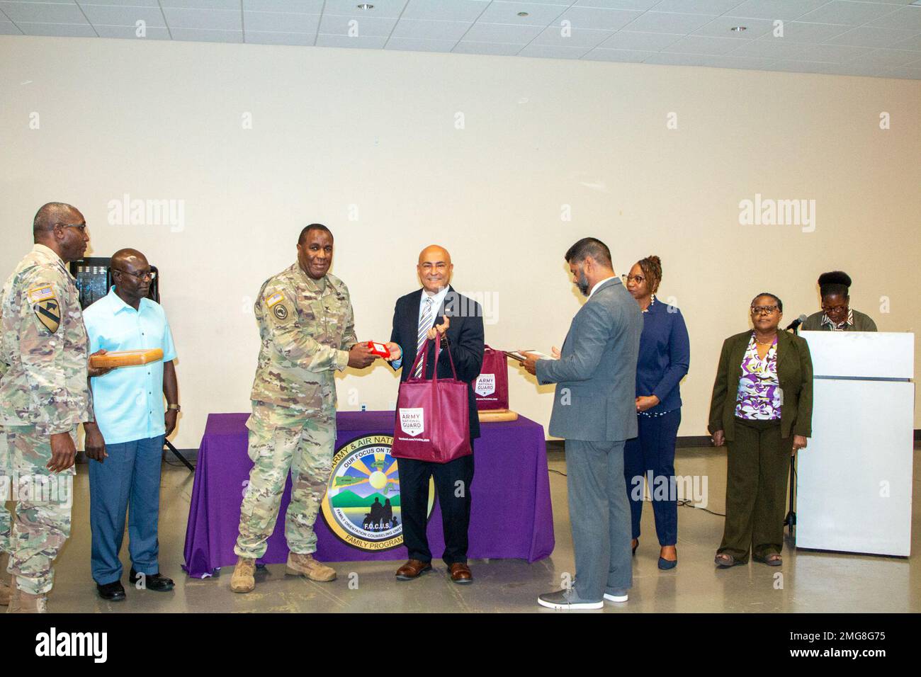 Col. Ivan Udell, left of center, shakes Mr. Angel Diaz hand, who is the ...