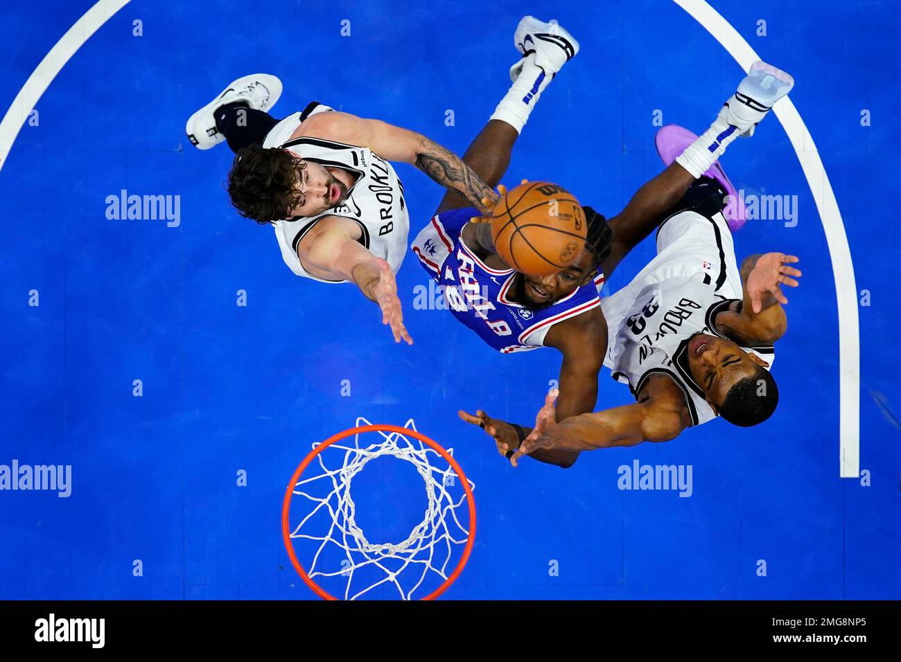 Philadelphia 76ers' Shake Milton, center, goes up for a shot against ...