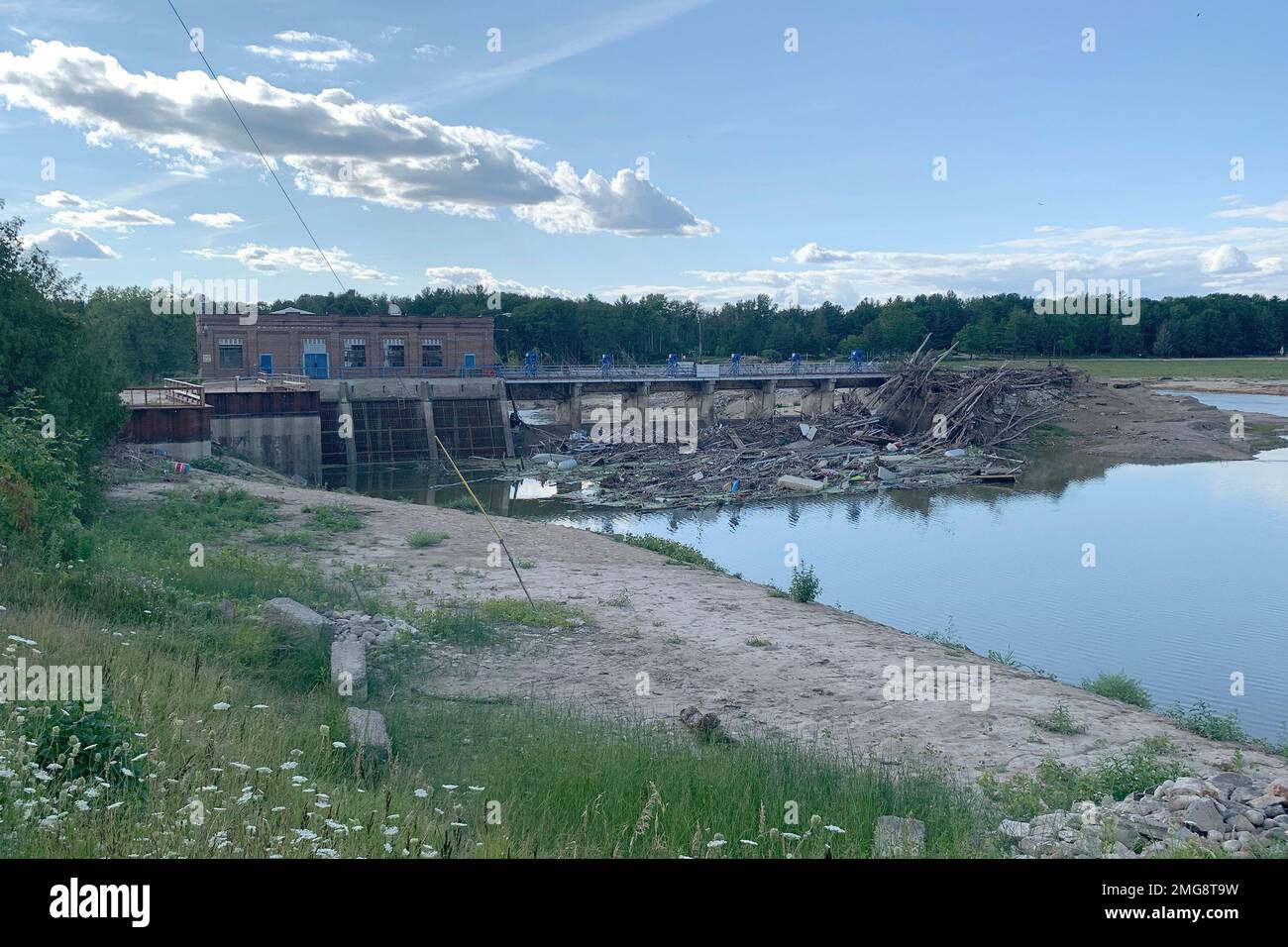 Debris rests at the spillway of the Sanford Dam in downtown Sanford ...