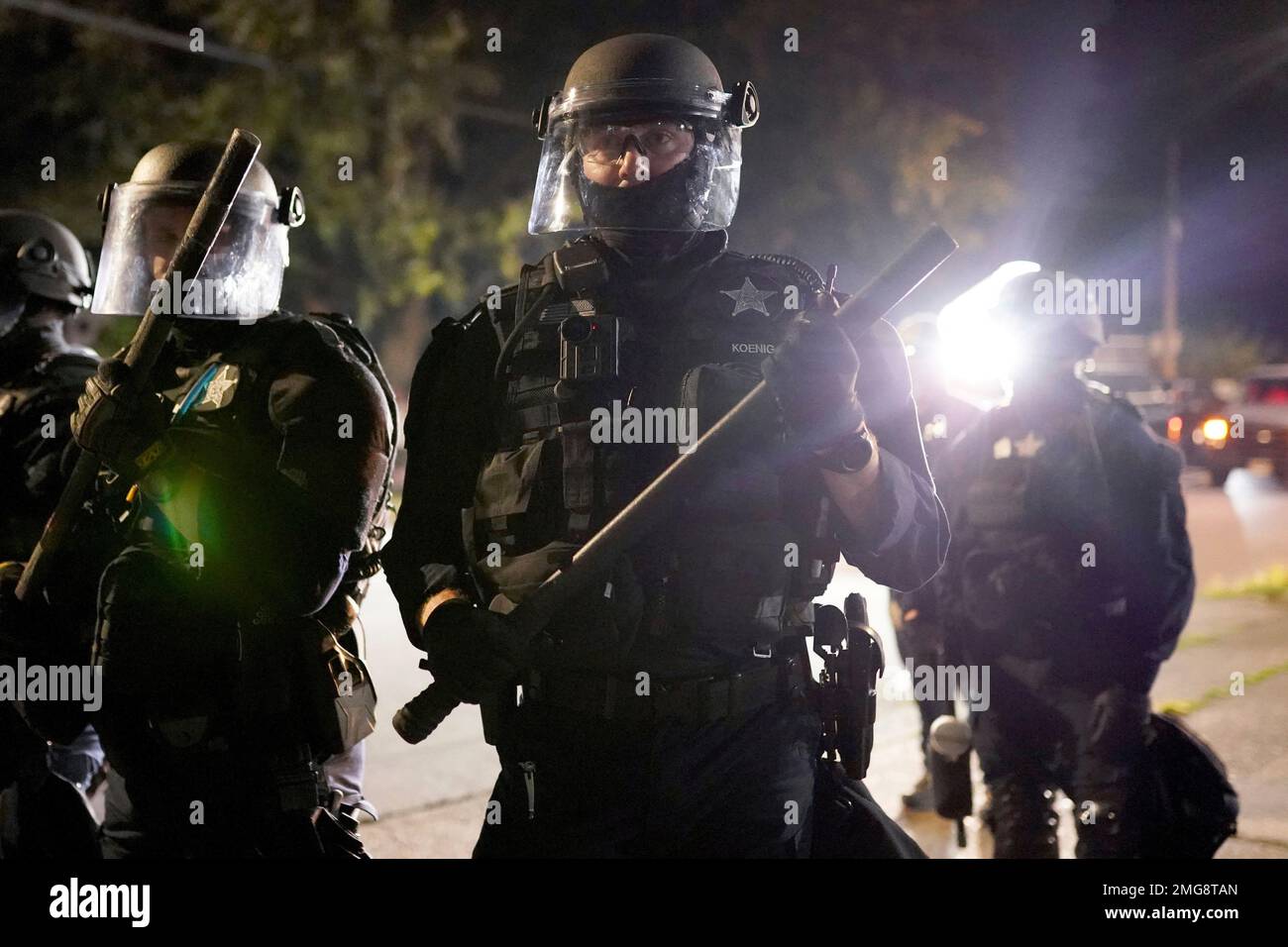 Portland police officers walk through the Laurelhurst neighborhood ...