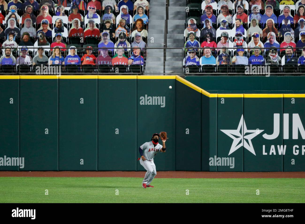 Los Angeles Angels' Brian Goodwin reaches up to field a fly out by the ...