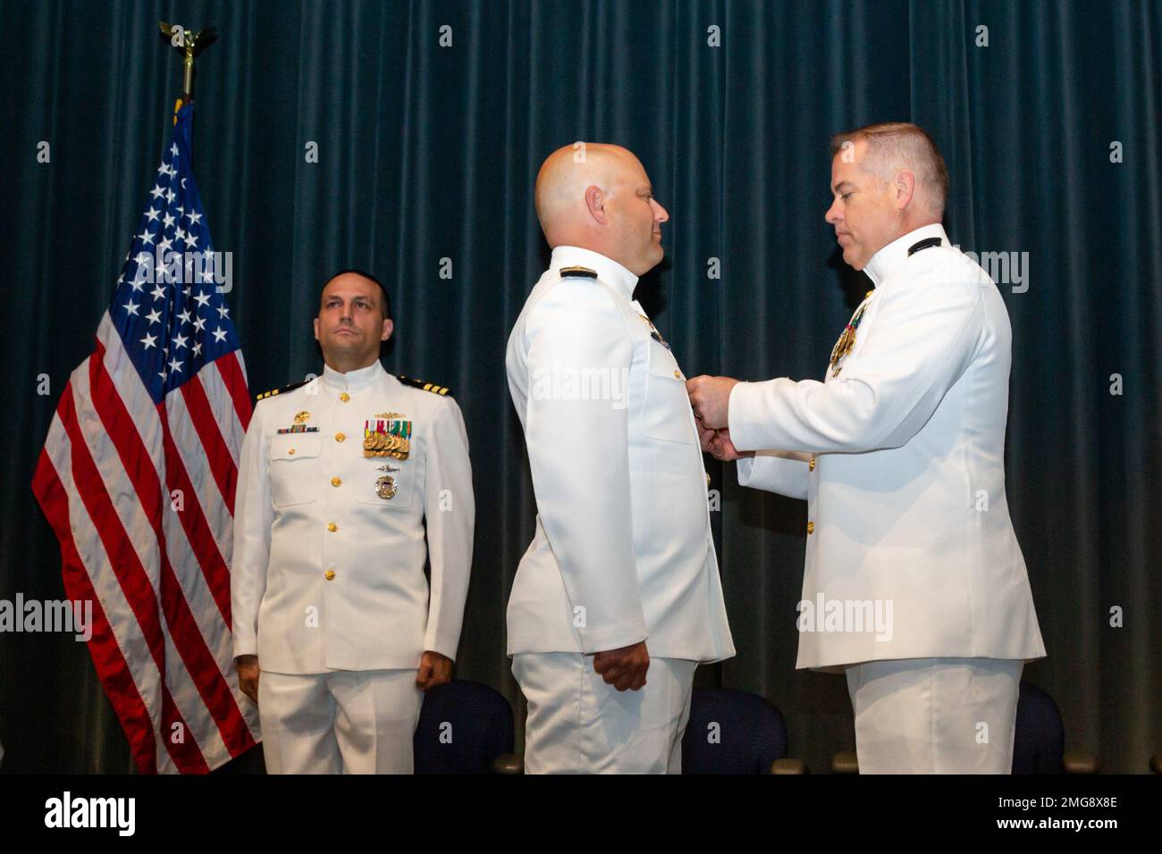 Capt. Charles McLenithan, right, commander, Submarine Squadron 17, pins ...