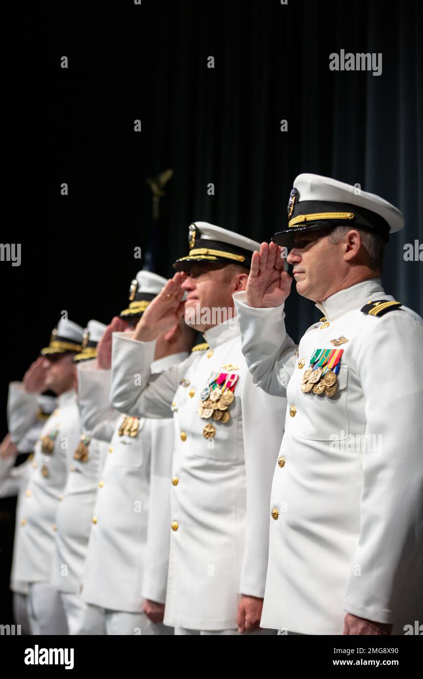 Members of the official party render salutes during a change of command ...