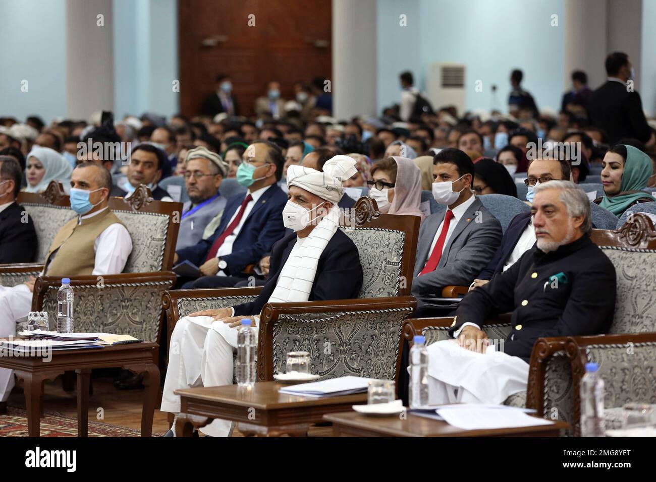 Afghan President Ashraf Ghani, center, wearing a protective face mask ...