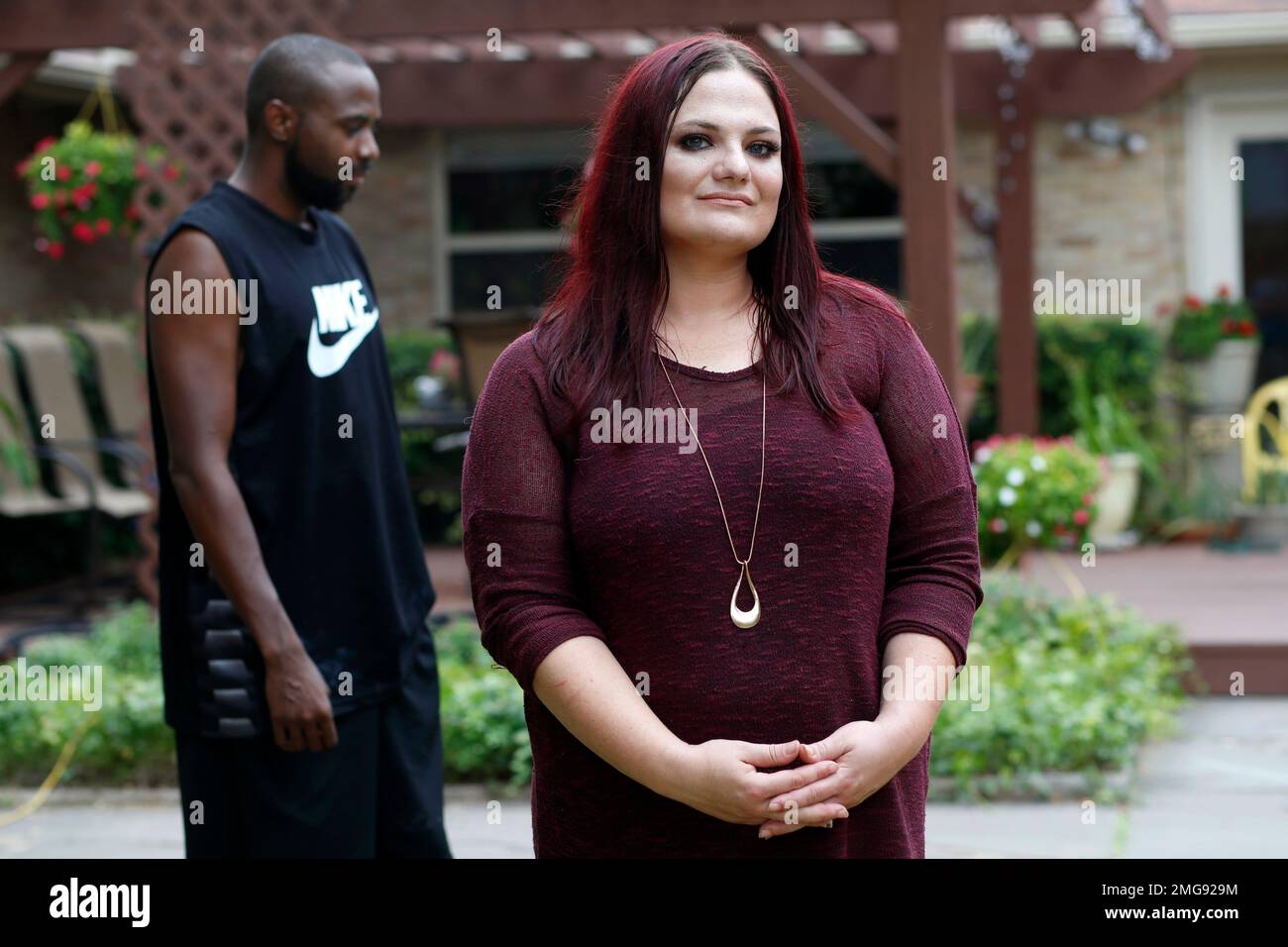 Bethany Racobs-Ashford poses for a photo with her husband, Chase, rear ...