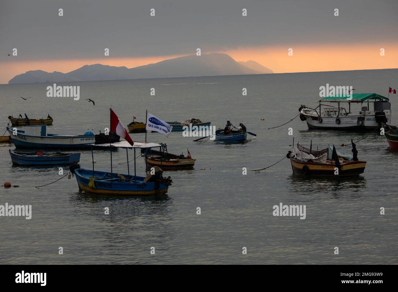 Fishermen return from work at dusk to the Chorrillos fishermen's cove ...