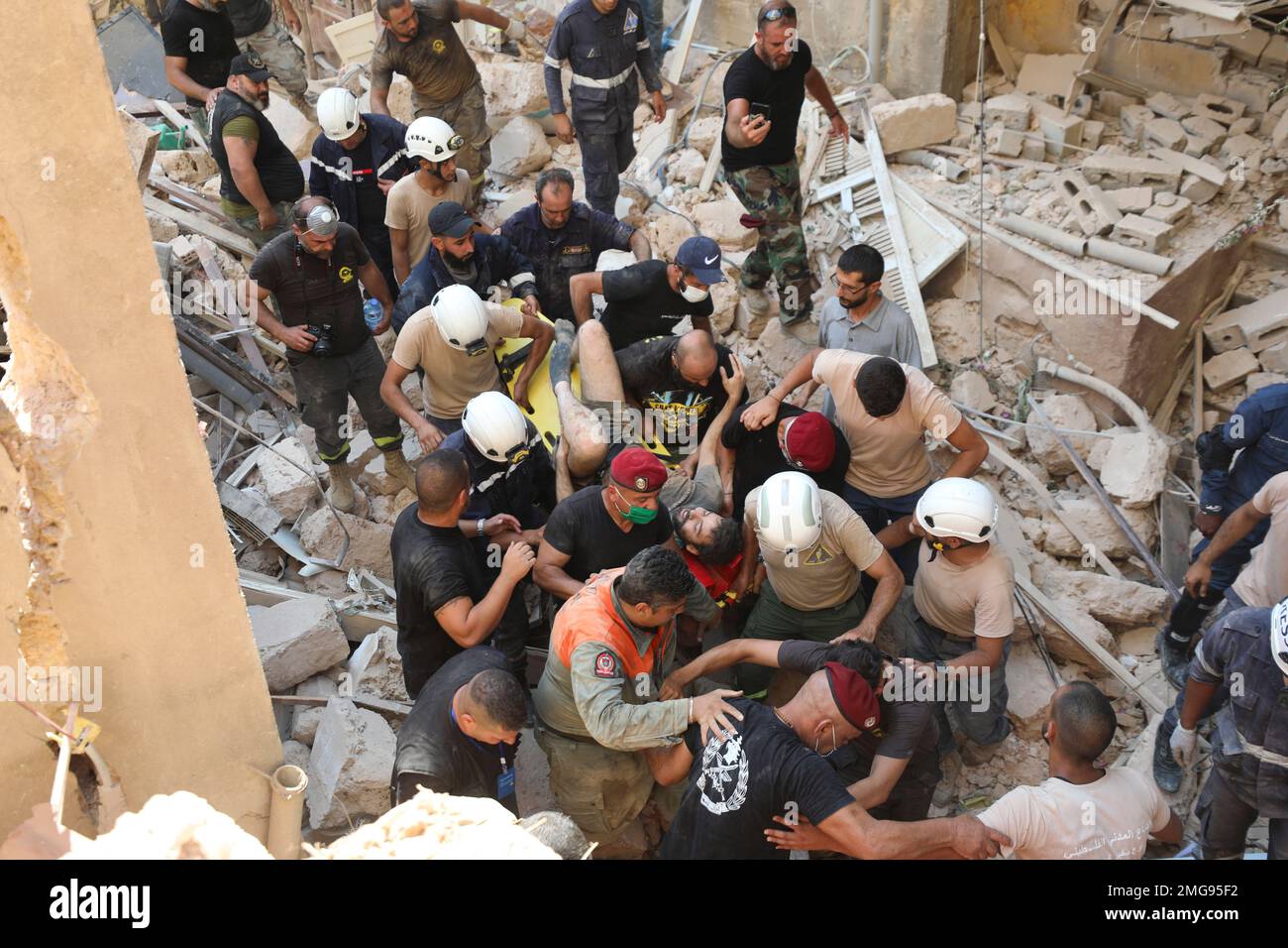 A survivor is taken out of the rubble after a massive explosion in ...