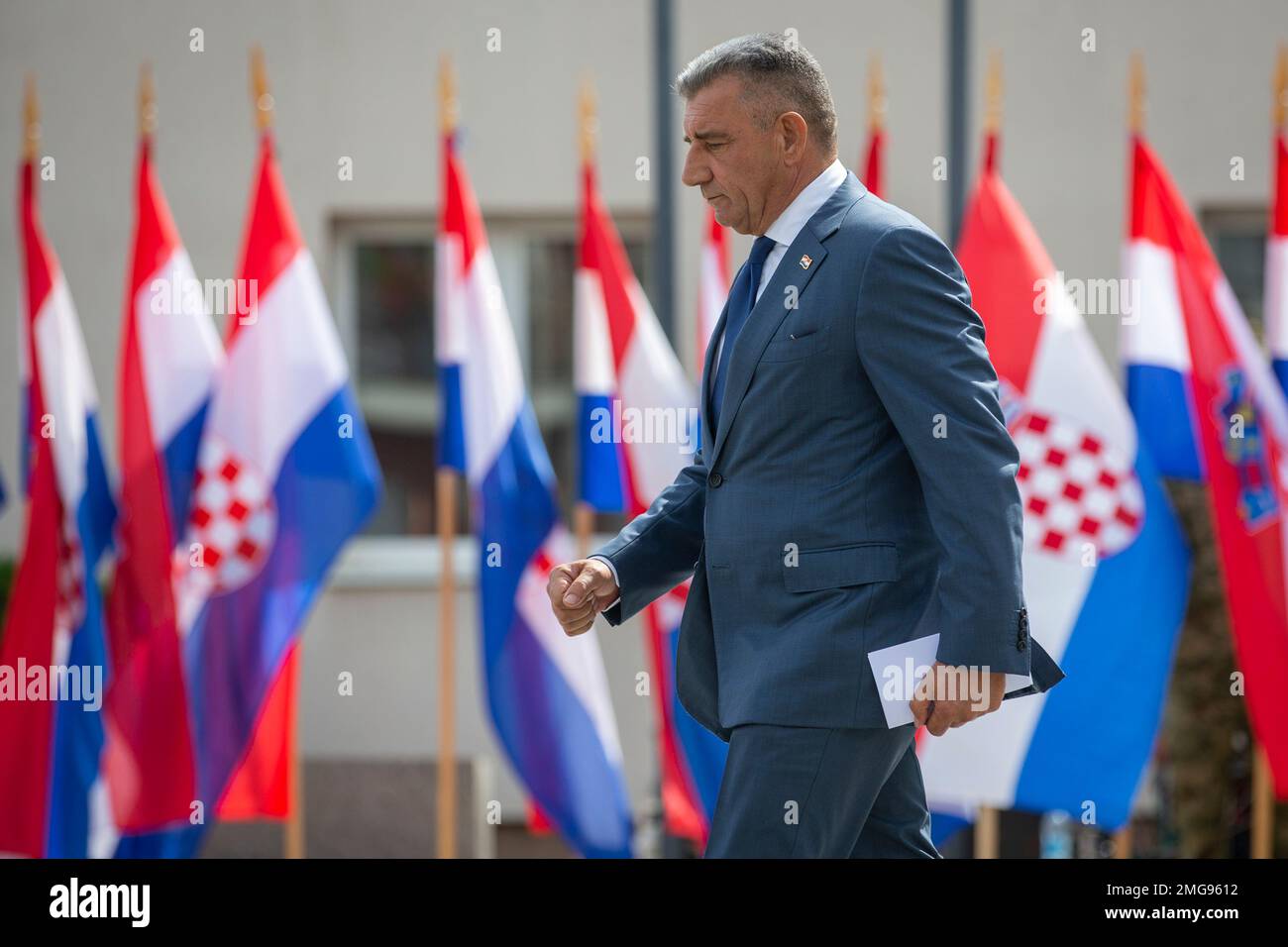 Croatian Gen. Ret. Ante Gotovina walks past Croatian flags during a ...