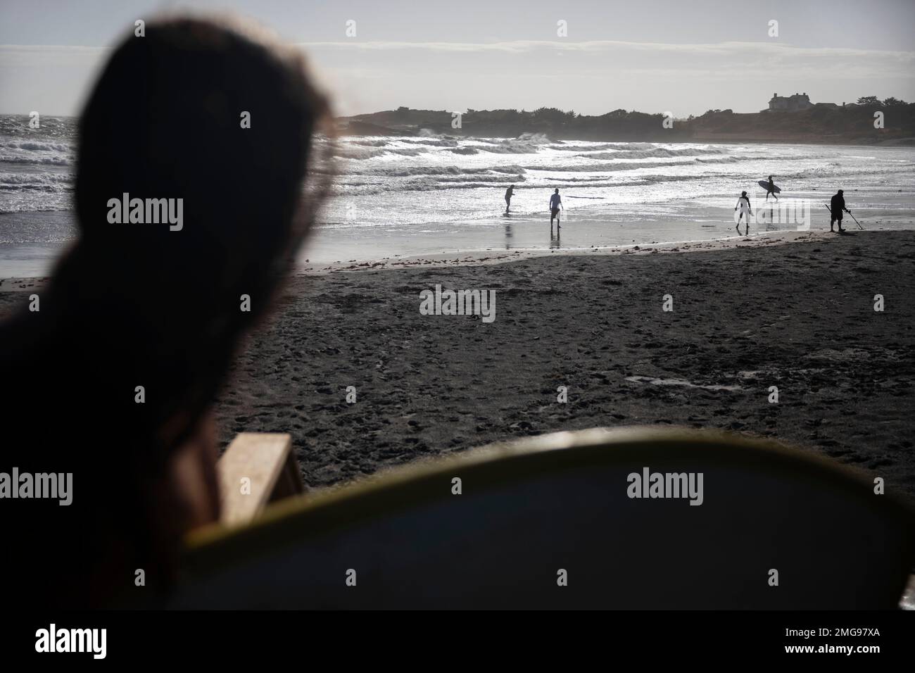 Beach goers walk along the high surf on Bailey's Beach as the effects ...