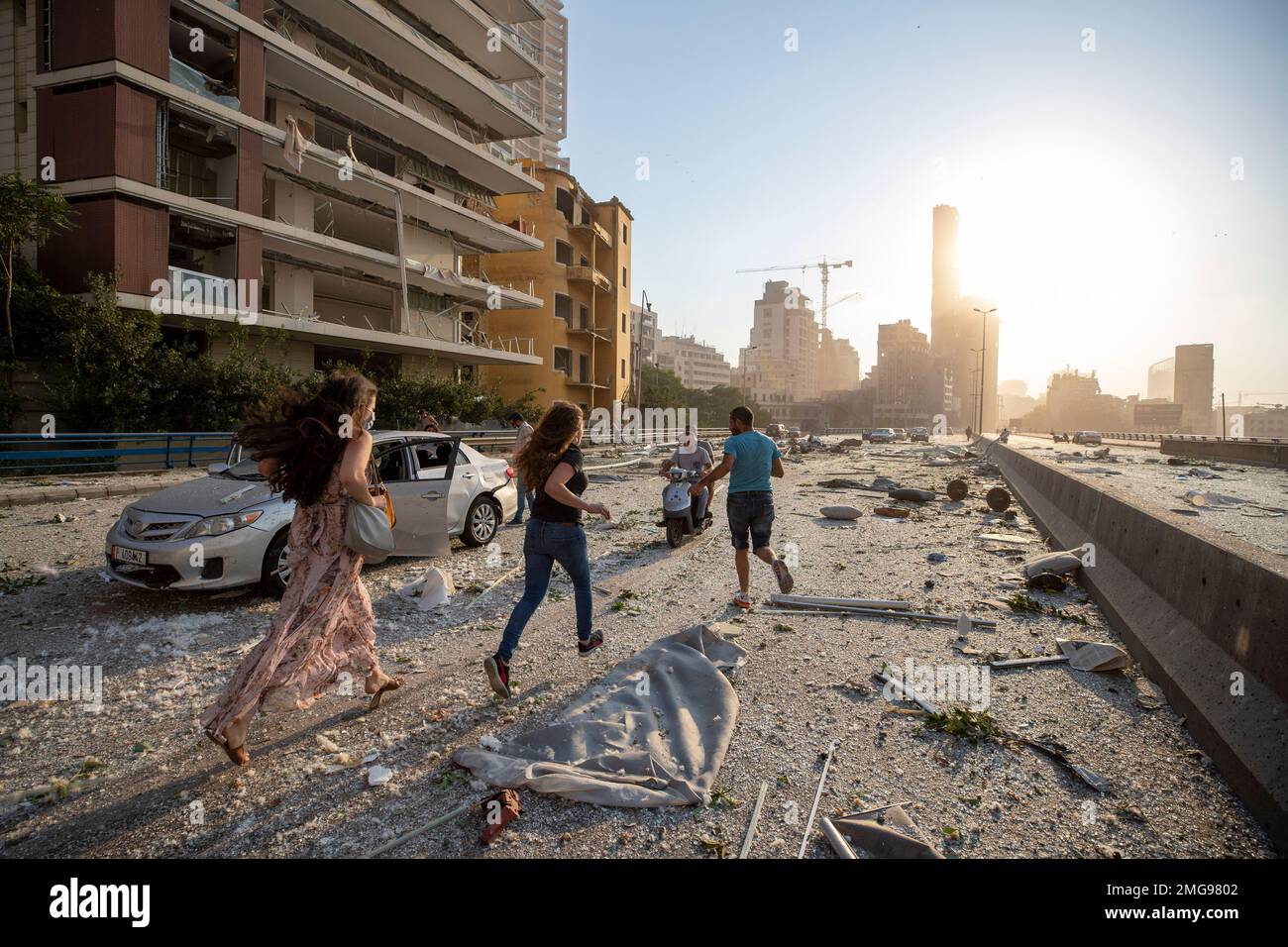 People run in the aftermath of a massive explosion in Beirut, Lebanon ...