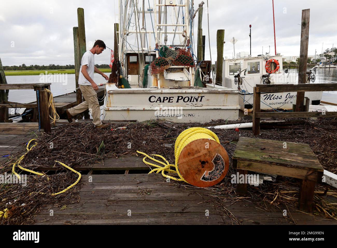Royce Potter walks past his boat following the effects of Hurricane ...