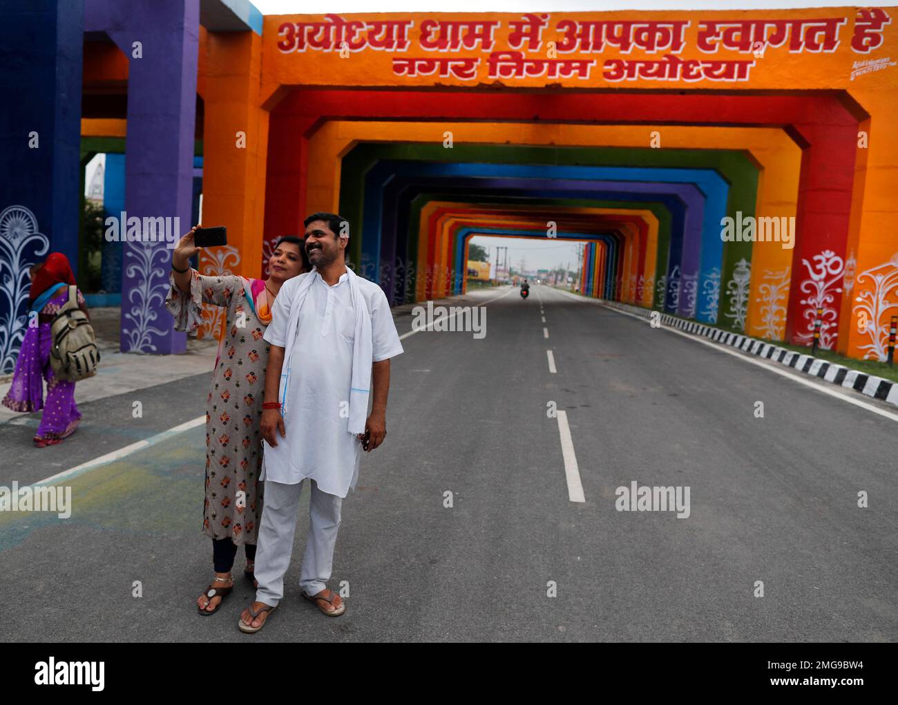 A couple takes a selfie in front of a decorated gate of Ayodhya city ...