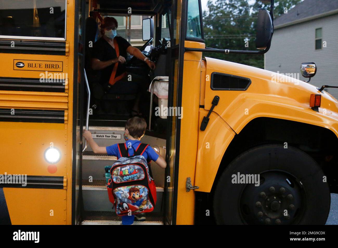 Paul Adamus, 7, climbs the stairs of a bus before the fist day of ...
