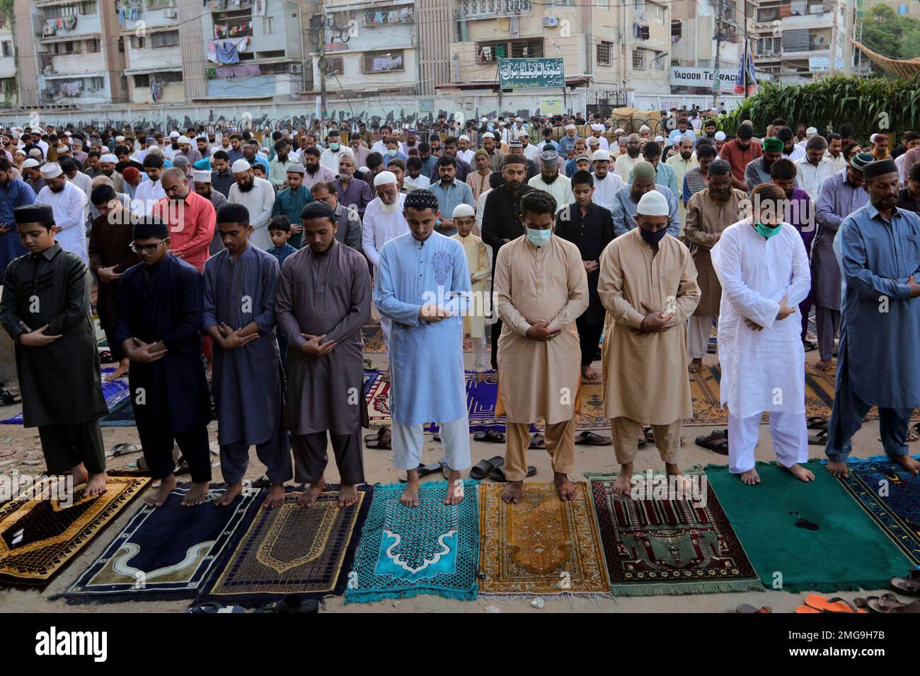 People offer Eid al-Adha prayers at a mosque in Karachi, Pakistan ...