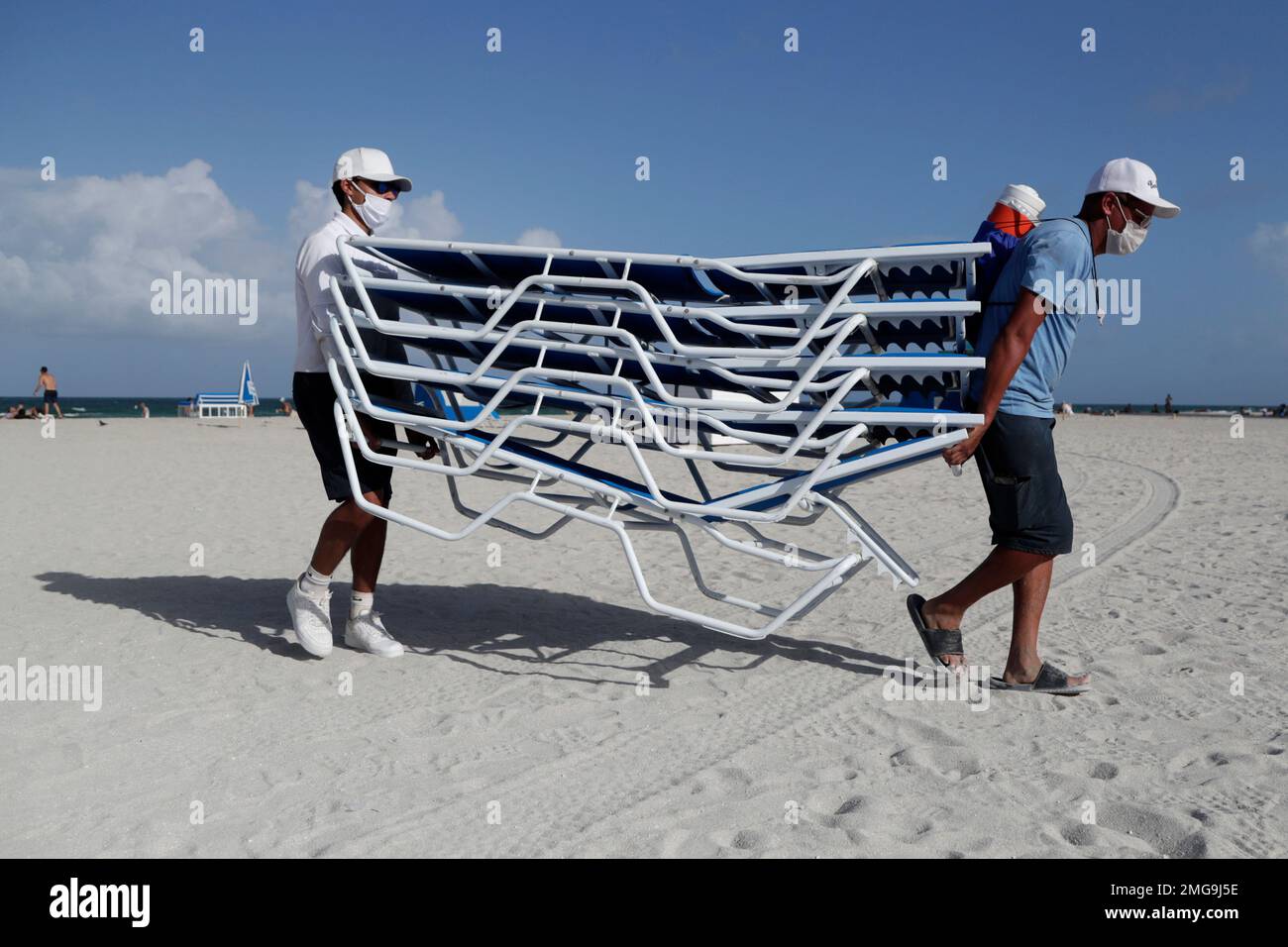 Workers remove chairs from the beach in preparation for Hurricane ...