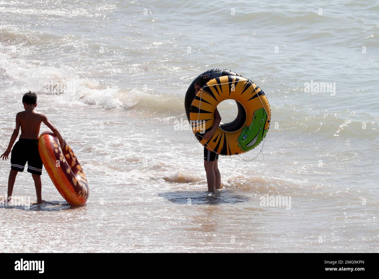 Beachgoers enjoy the sunshine and sea on what is now Britain's hottest ...