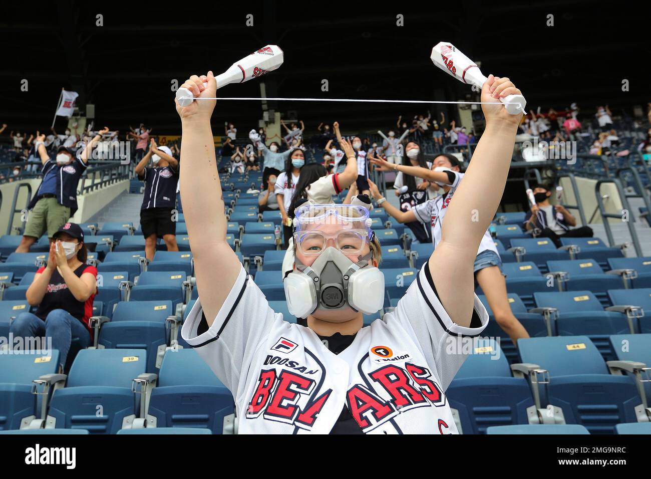 A fan wearing a face masks to help protect against the spread of the ...