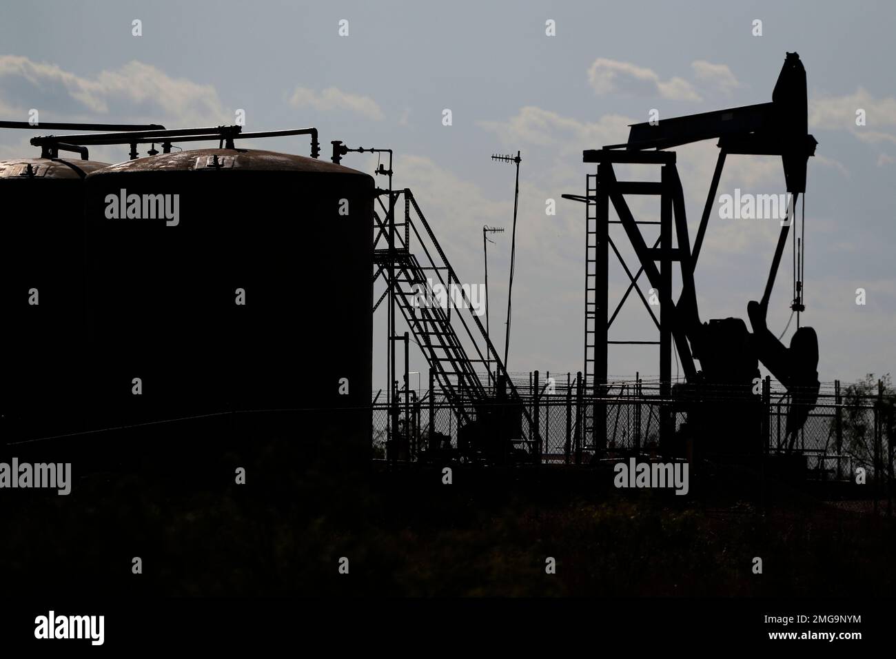 A pump jack operates in an oil field, Wednesday, July 29, 2020, in ...