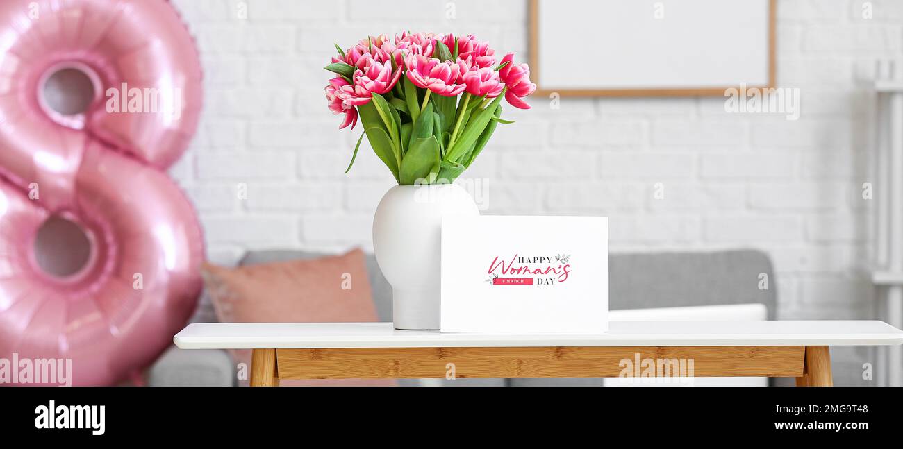 Vase with pink tulips and greeting card with text HAPPY WOMAN'S DAY on ...