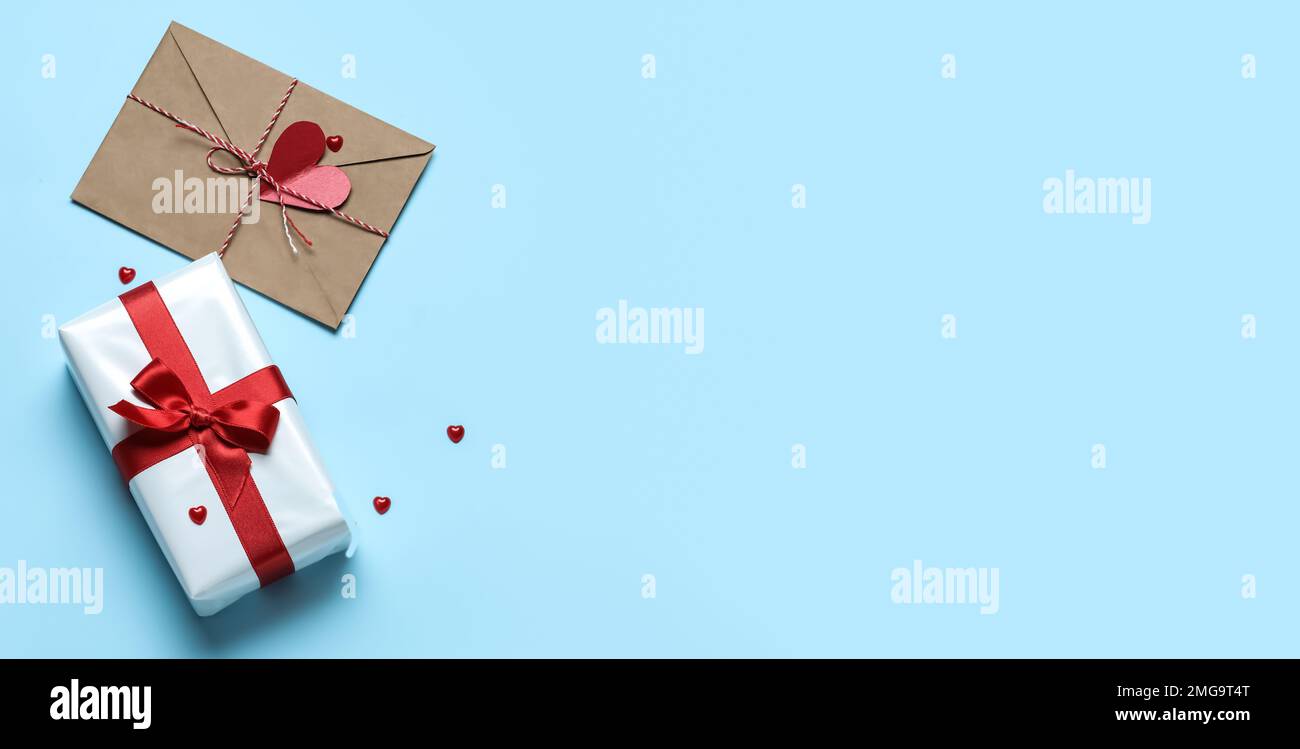Gift box for Valentine's Day and envelope on light blue background with ...