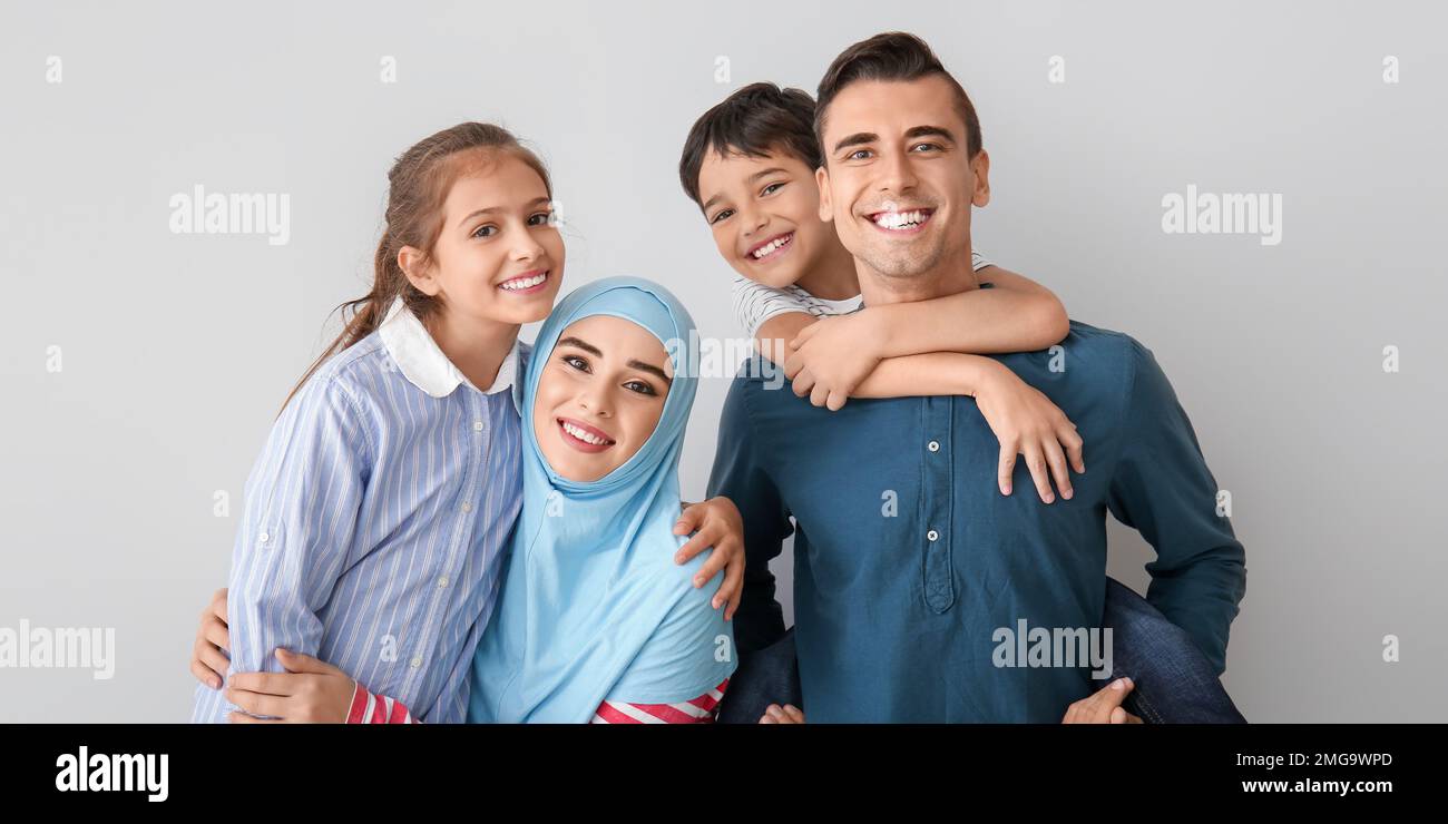 Portrait of happy Muslim family on light background Stock Photo - Alamy