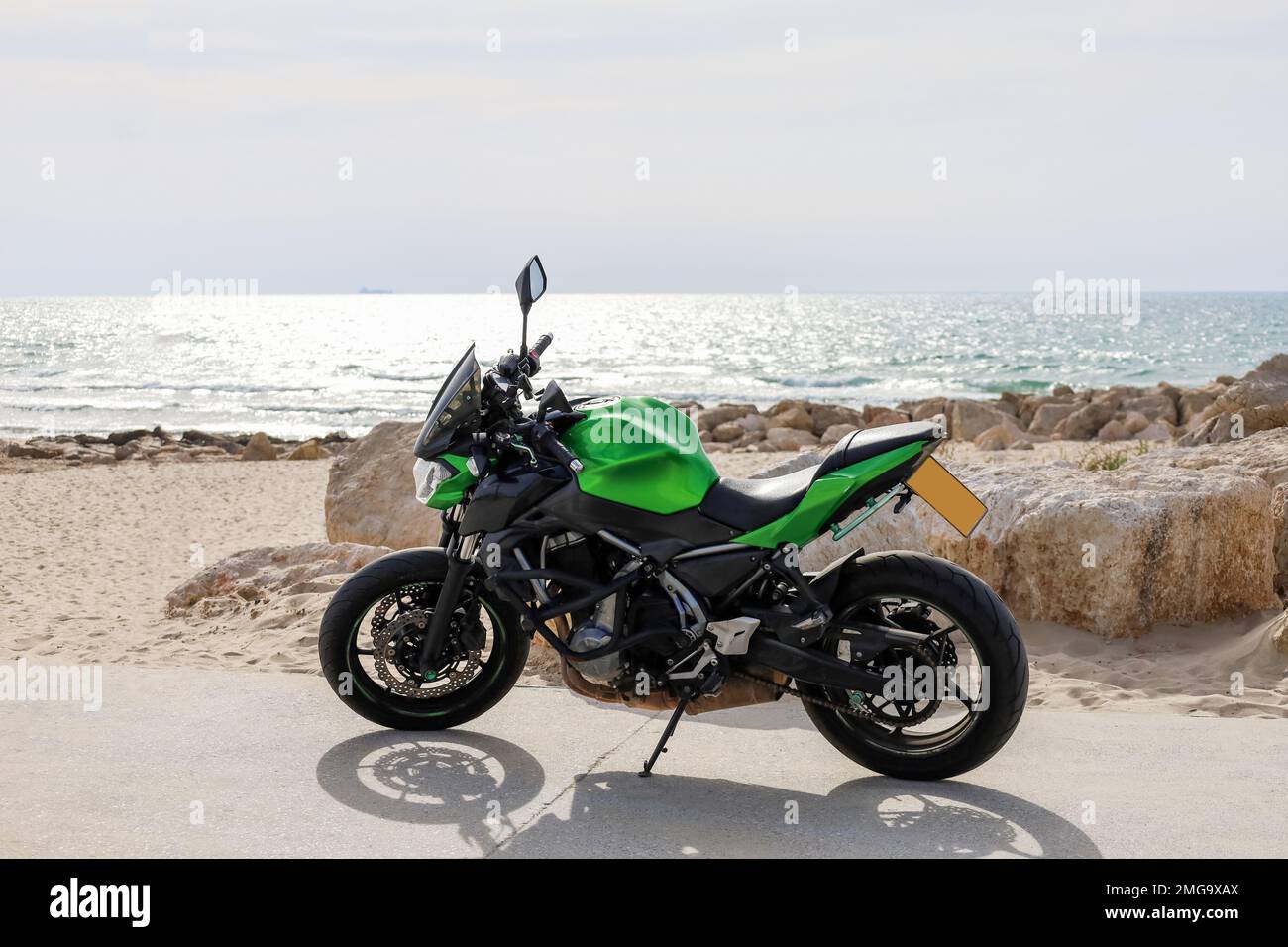 Modern motorcycle parked on city beach Stock Photo - Alamy