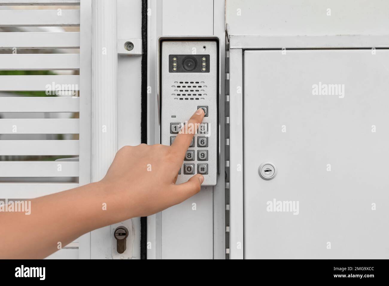 Little girl using modern intercom outdoors, closeup Stock Photo - Alamy