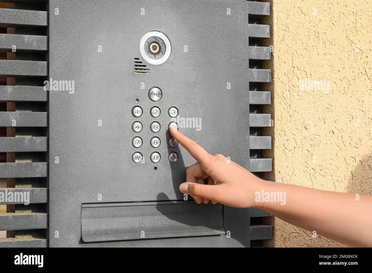 Little girl using modern intercom outdoors, closeup Stock Photo - Alamy