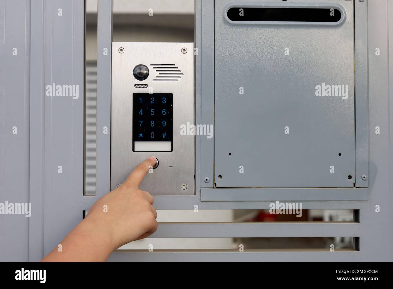 Little girl using modern intercom outdoors, closeup Stock Photo - Alamy
