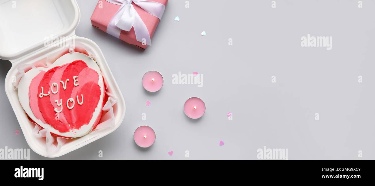 Sweet bento cake for Valentine's Day, gift and candles on light ...