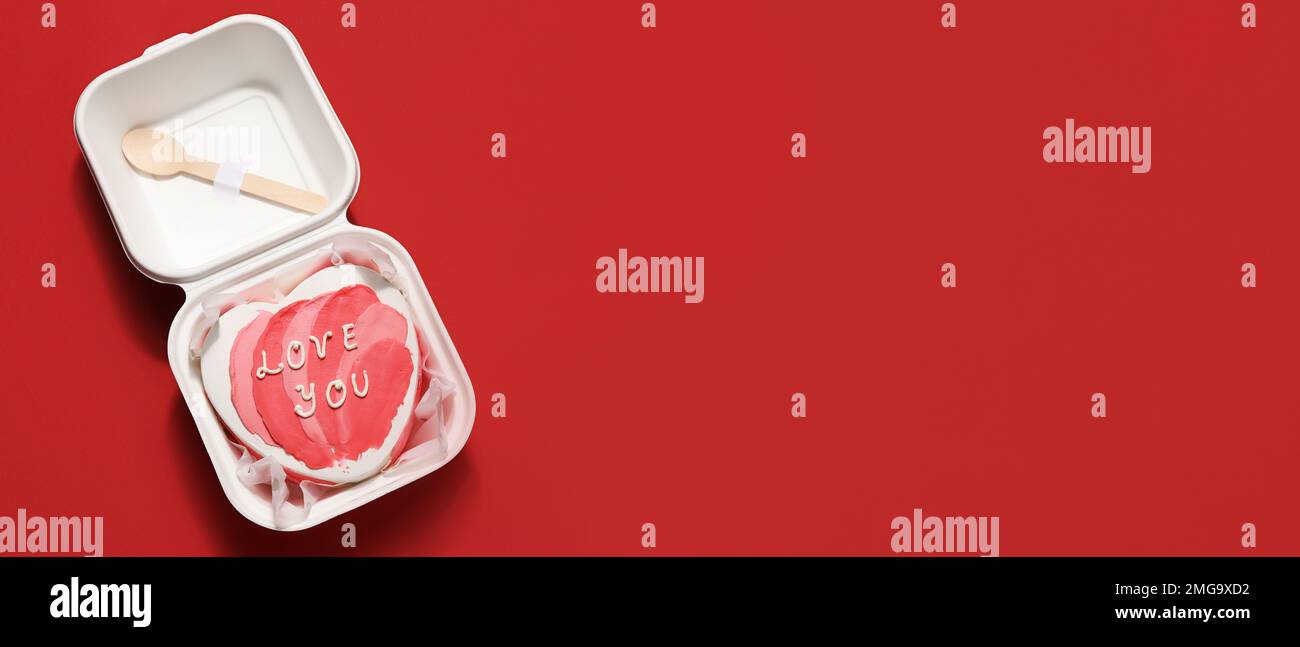 Sweet bento cake for Valentine's Day on red background with space for ...