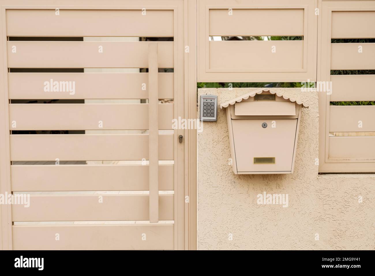 Modern fence with intercom and mailbox outdoors Stock Photo - Alamy