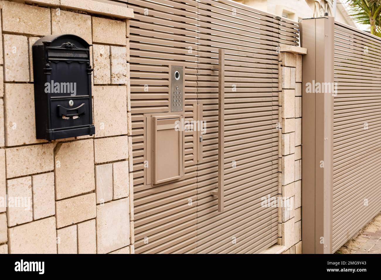 Modern fence with intercom and door outdoors Stock Photo - Alamy
