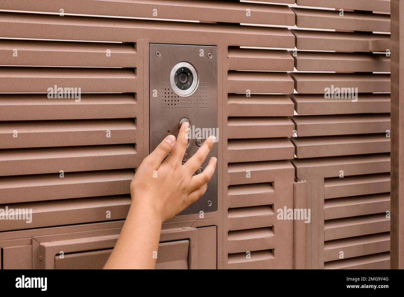 Child using intercom on fence outdoors, closeup Stock Photo - Alamy