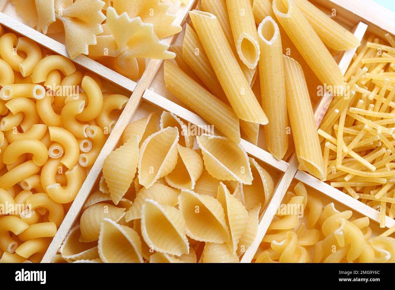 Box with different types of raw pasta, closeup Stock Photo - Alamy
