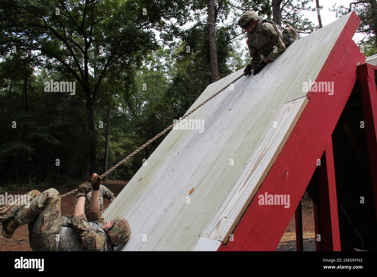SPC Alyssa Reyes and SGT Collin Roberts navigate an obstacle at the ...