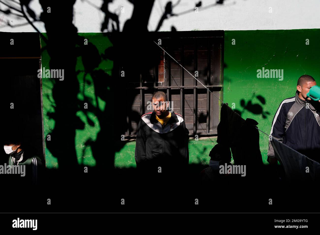 Inmates stand in the outdoor patio of Tacumbu jail, the largest prison ...